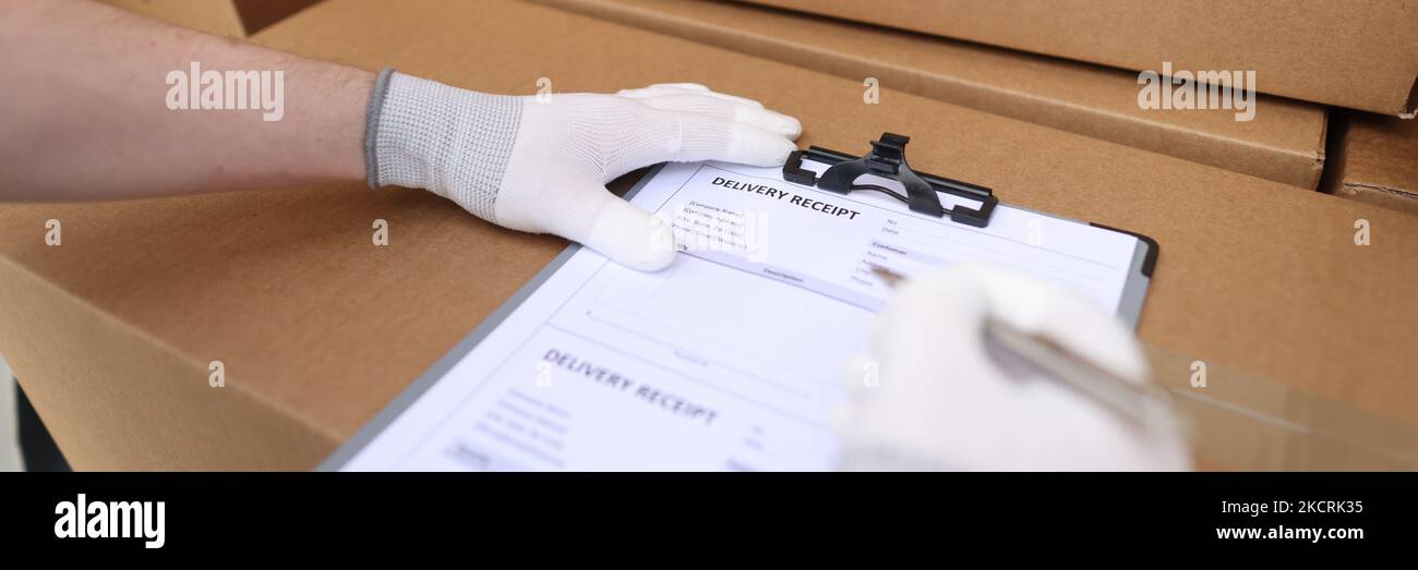 Courier service filling delivery receipt with client Stock Photo - Alamy