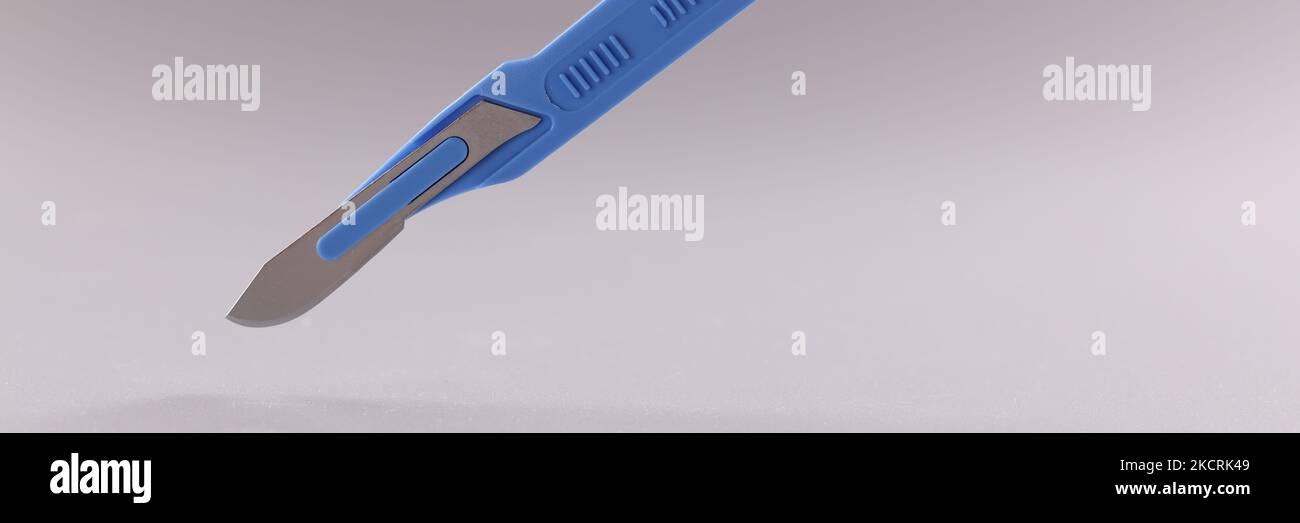 Scalpel, surgical stainless steel metal instrument on grey background ...