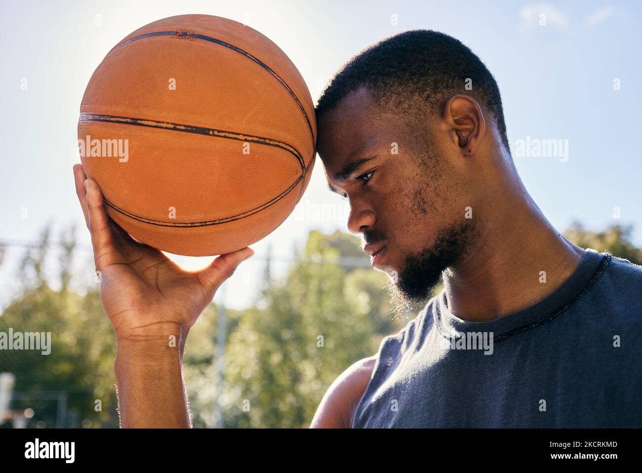 Basketball on forehead, motivation and black man on basketball court ...