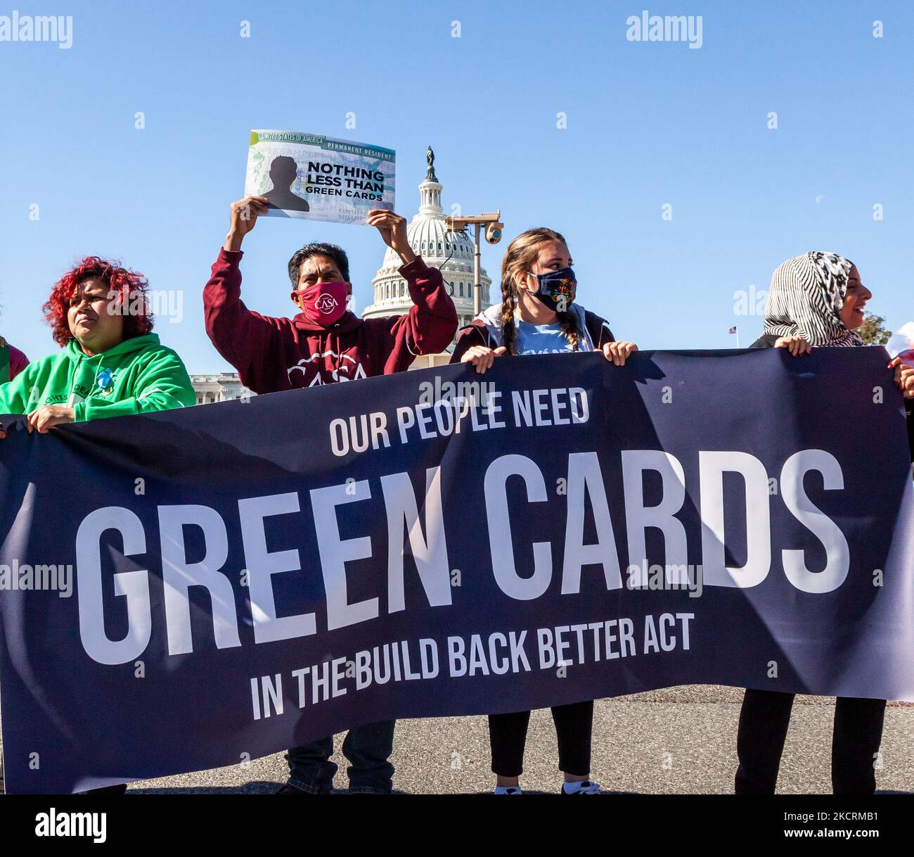 Protesters hold signs with some of their demands of Congress during a ...