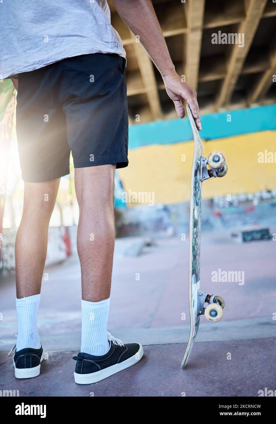 Legs, skateboard and man at skate park, urban and skating for fun and ...