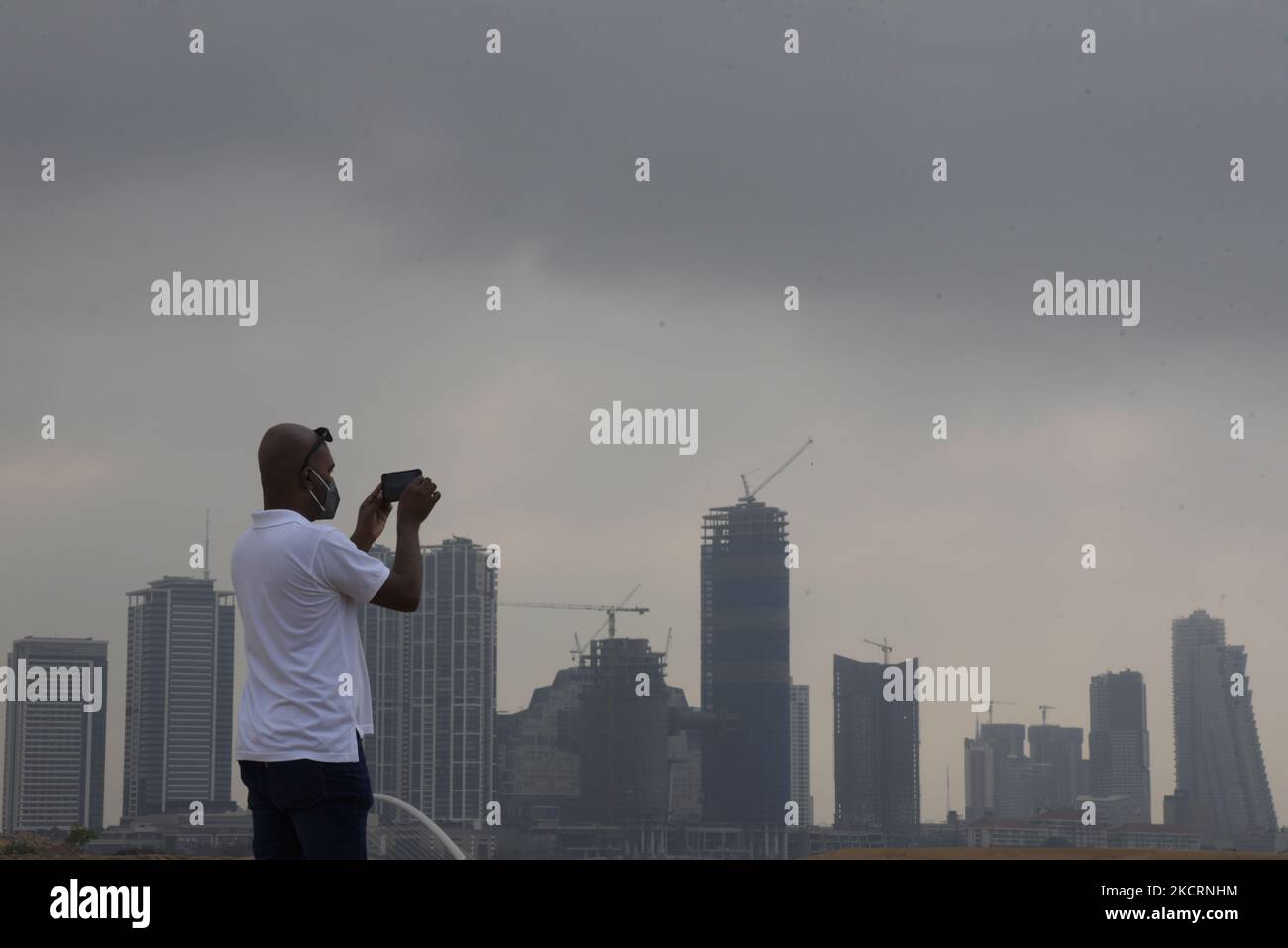 A man takes a picture background seen rain clouds in Colombo main city ...