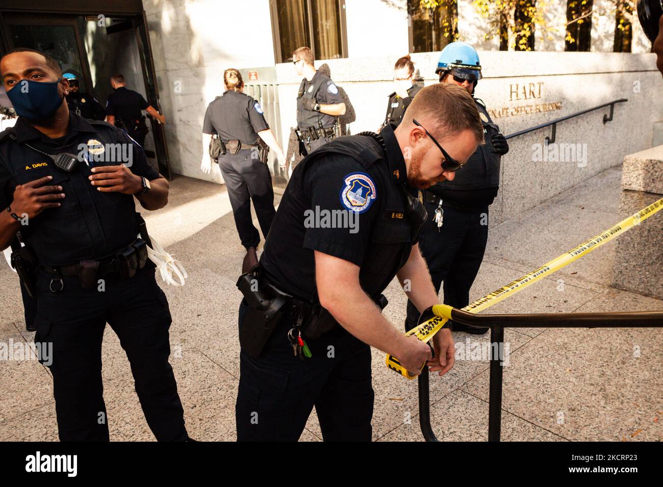 Police officer puts up police tape hi-res stock photography and images ...