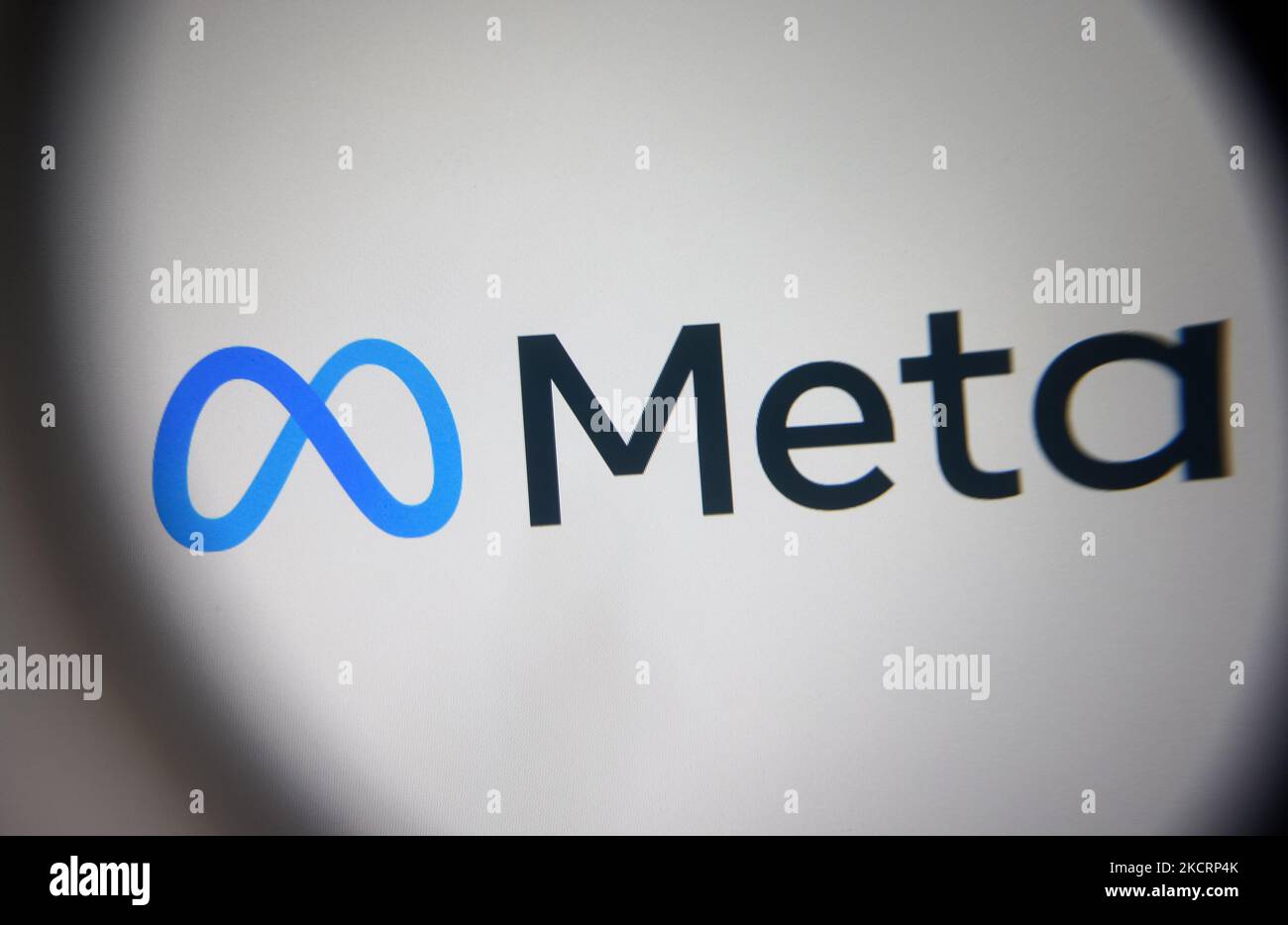 Meta Platforms Inc. logo is pictured through a magnifying glass in this ...