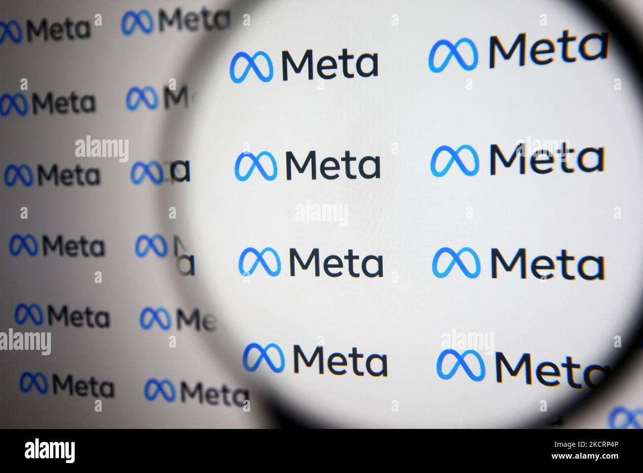 Meta Platforms Inc. logo is pictured through a magnifying glass in this ...