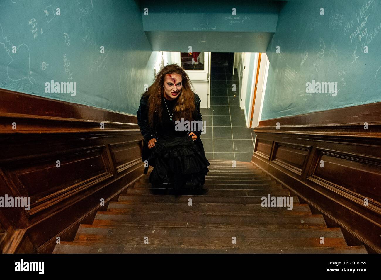 A female zombie is taking the stairs, before the Zombie walk organized ...