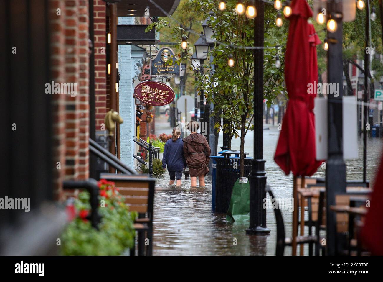 Children walk through flooded streets in Old Town Alexandria, Virginia ...