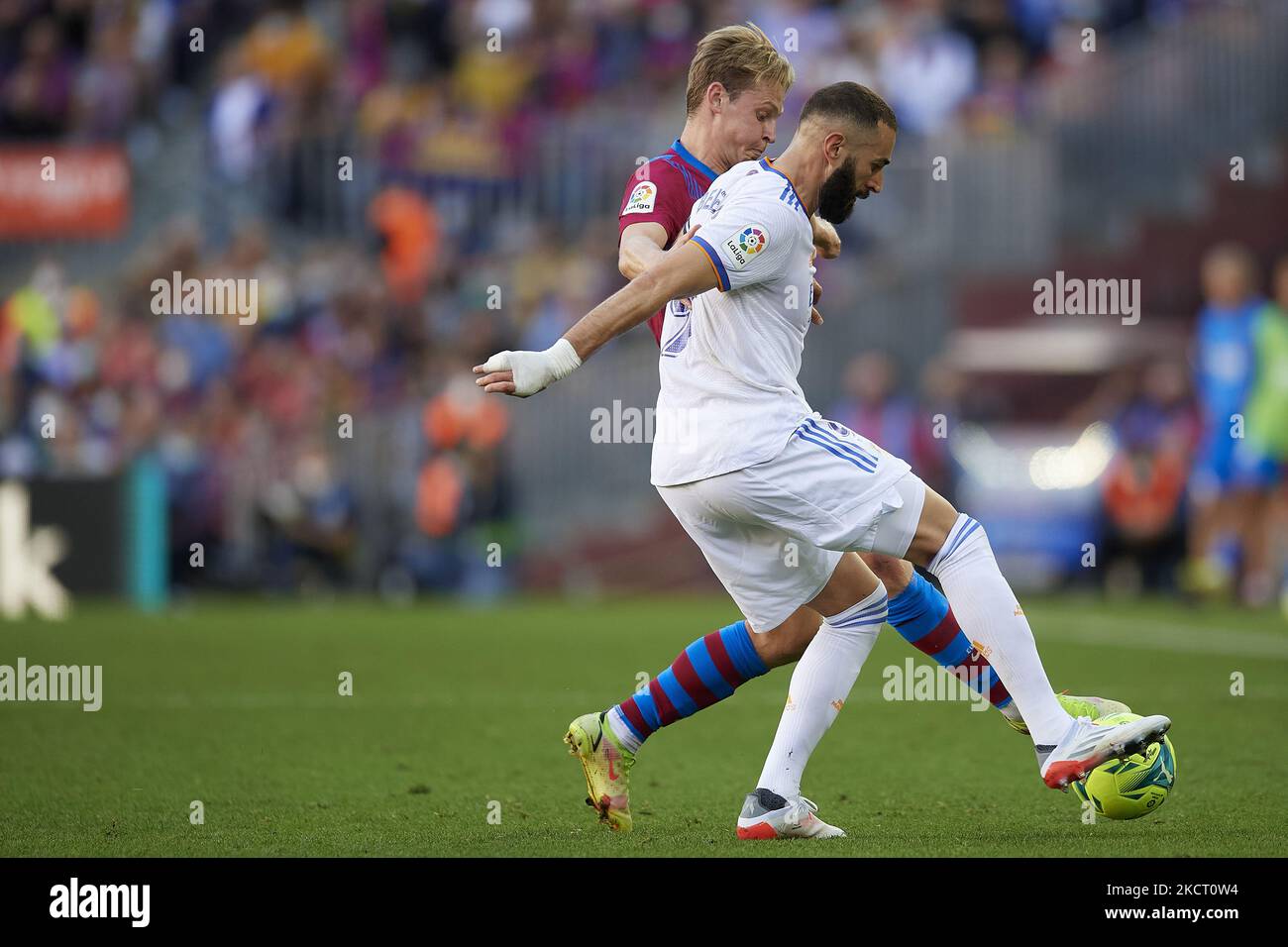 Karim Benzema of Real Madrid and Frenkie de Jong of Barcelona compete ...