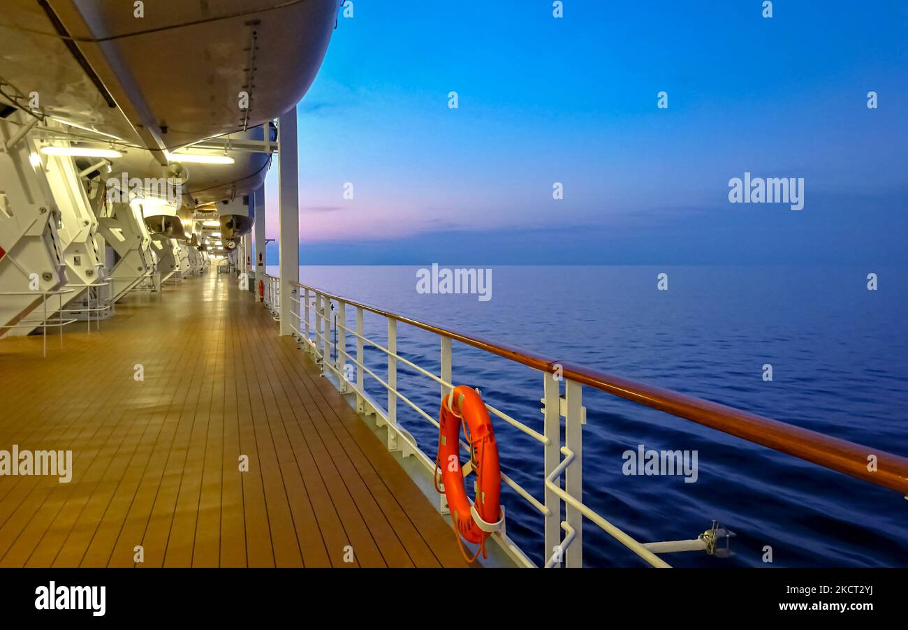 Promenade deck of a cruise ship in navigation with sunset Stock Photo ...
