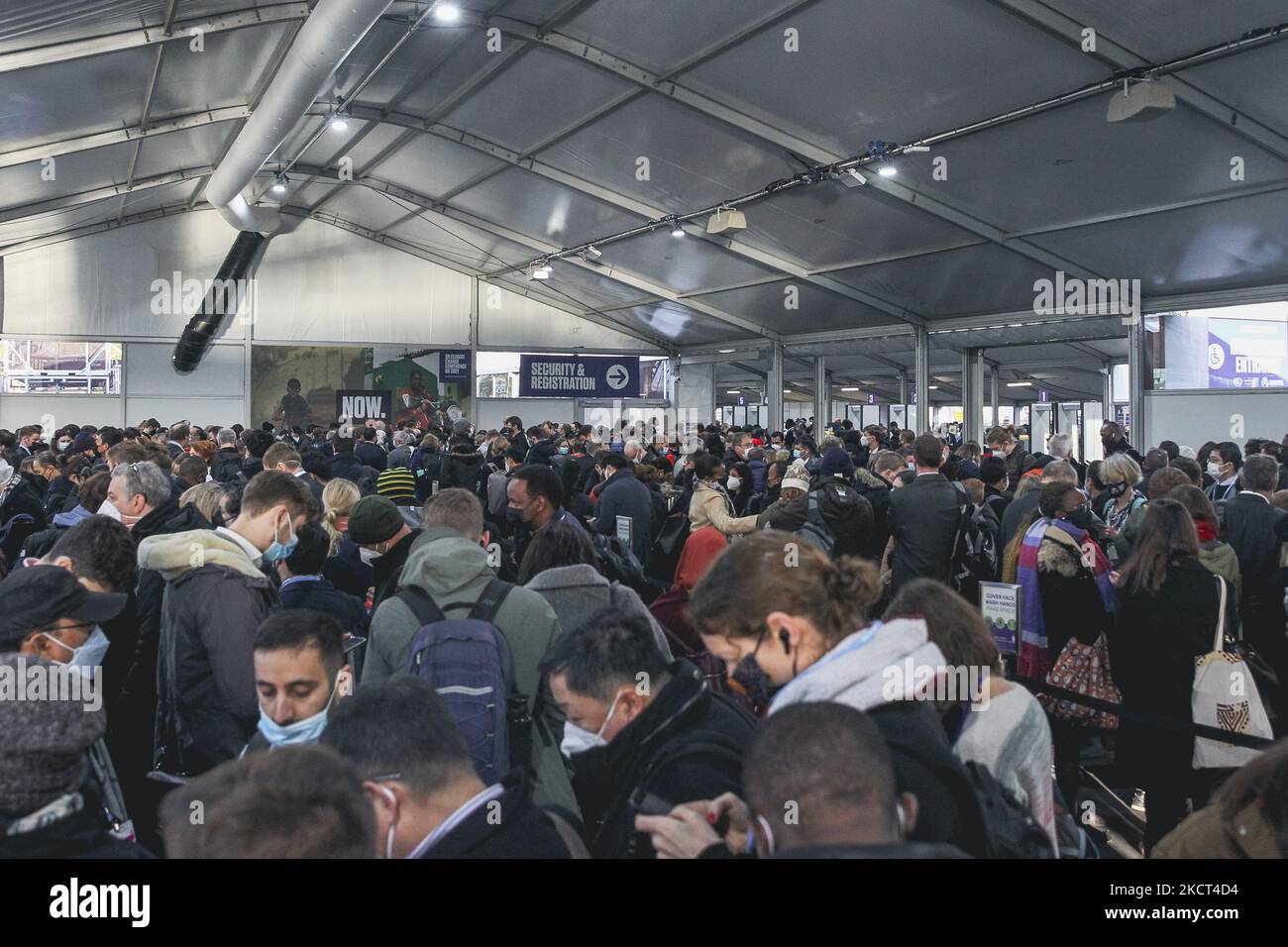 People wait outside the venue on day three of the COP 26 United Nations ...