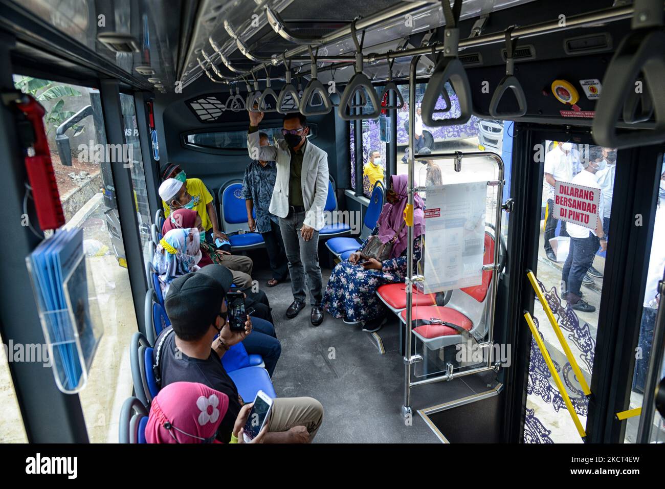 Passenger wearing a protective face mask sits in a Kita Trans Pakuan ...