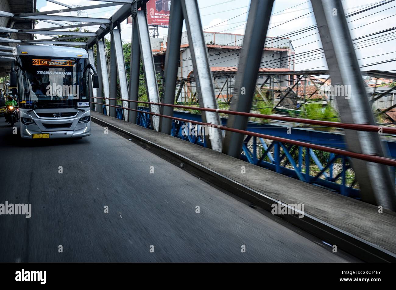 A Kita Trans Pakuan bus drives on a main road in Bogor, Indonesia on ...