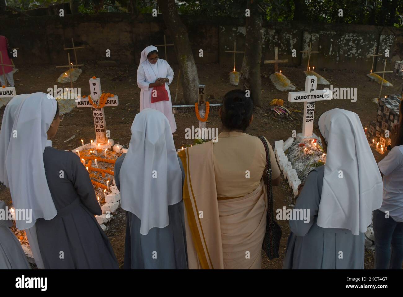 Nuns pay tribute to the deceased people on All Souls' Day, at a ...
