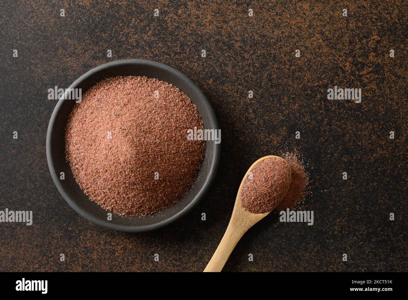 Indian Black salt, Kala namak in bowl and wooden spoon on brown ...