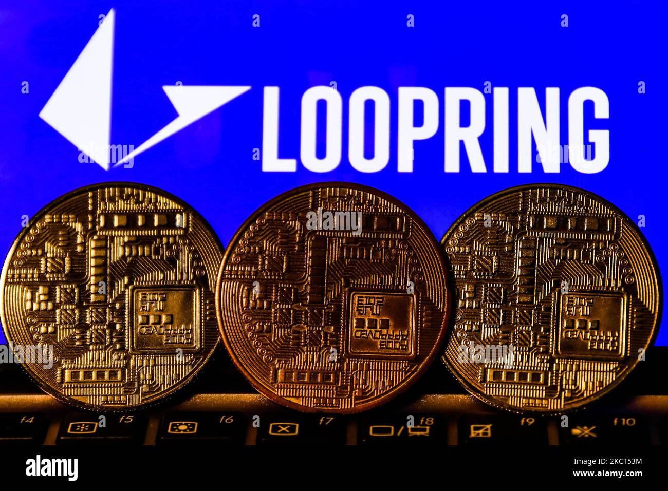 Loopring logo displayed on a phone screen and representation of ...