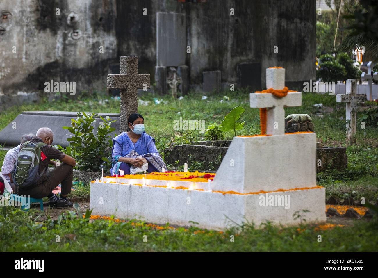 Christian devotees mourns on a grave of relative during the ...