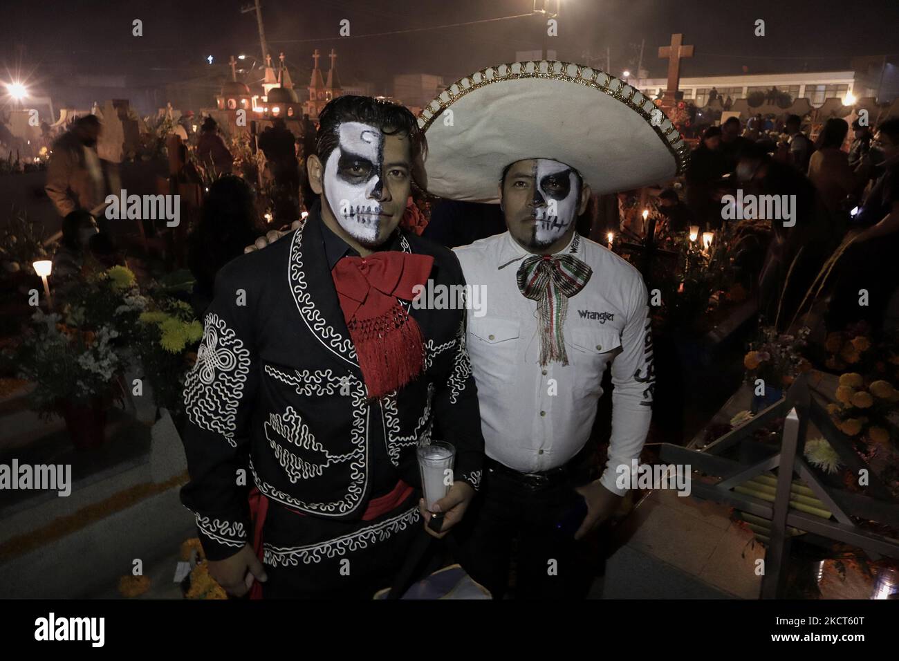Two people wearing skull and crossbones make-up and dressed as ...