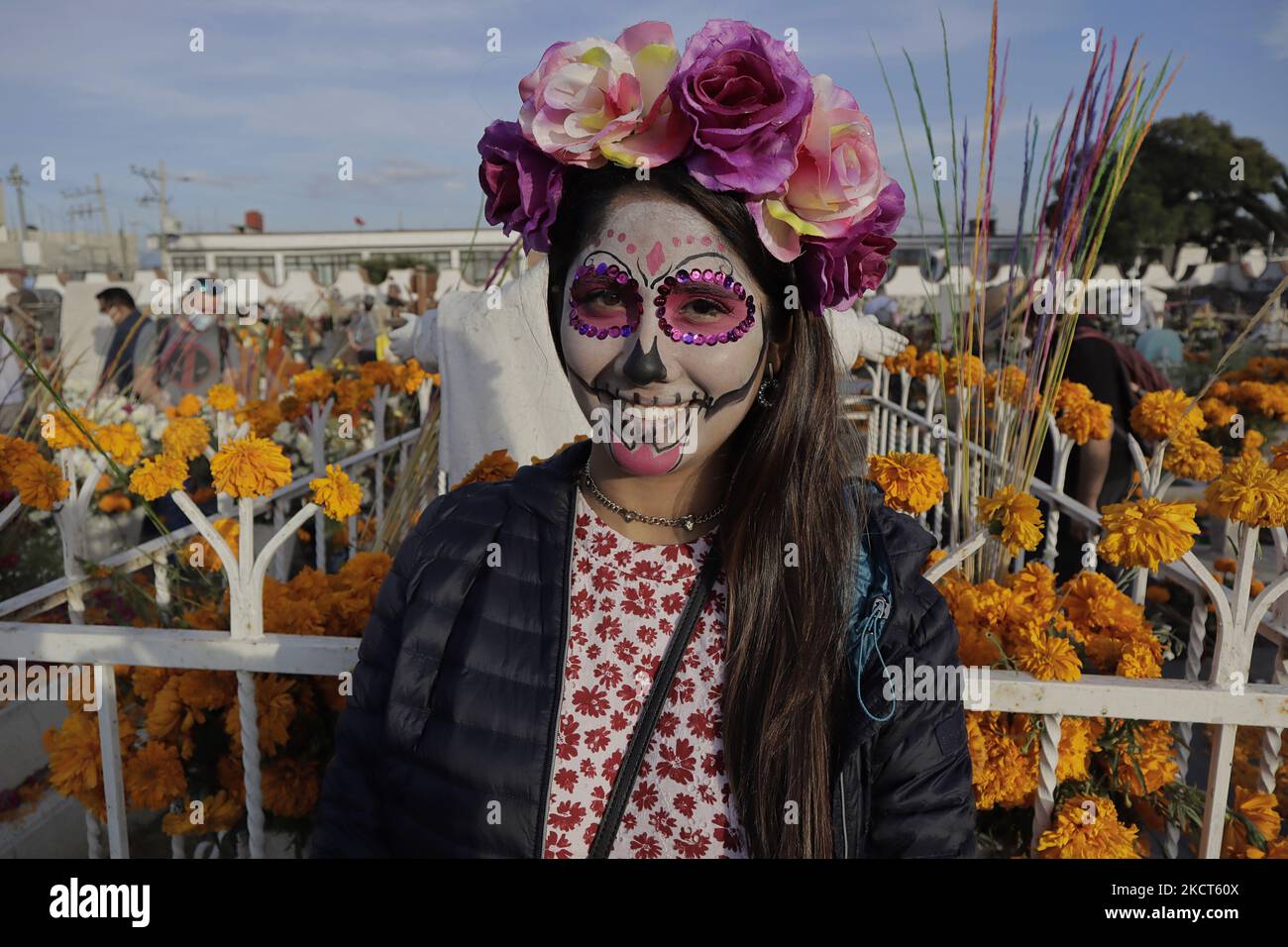 A woman wearing catrina make-up poses inside the cemetery of San Andrés ...