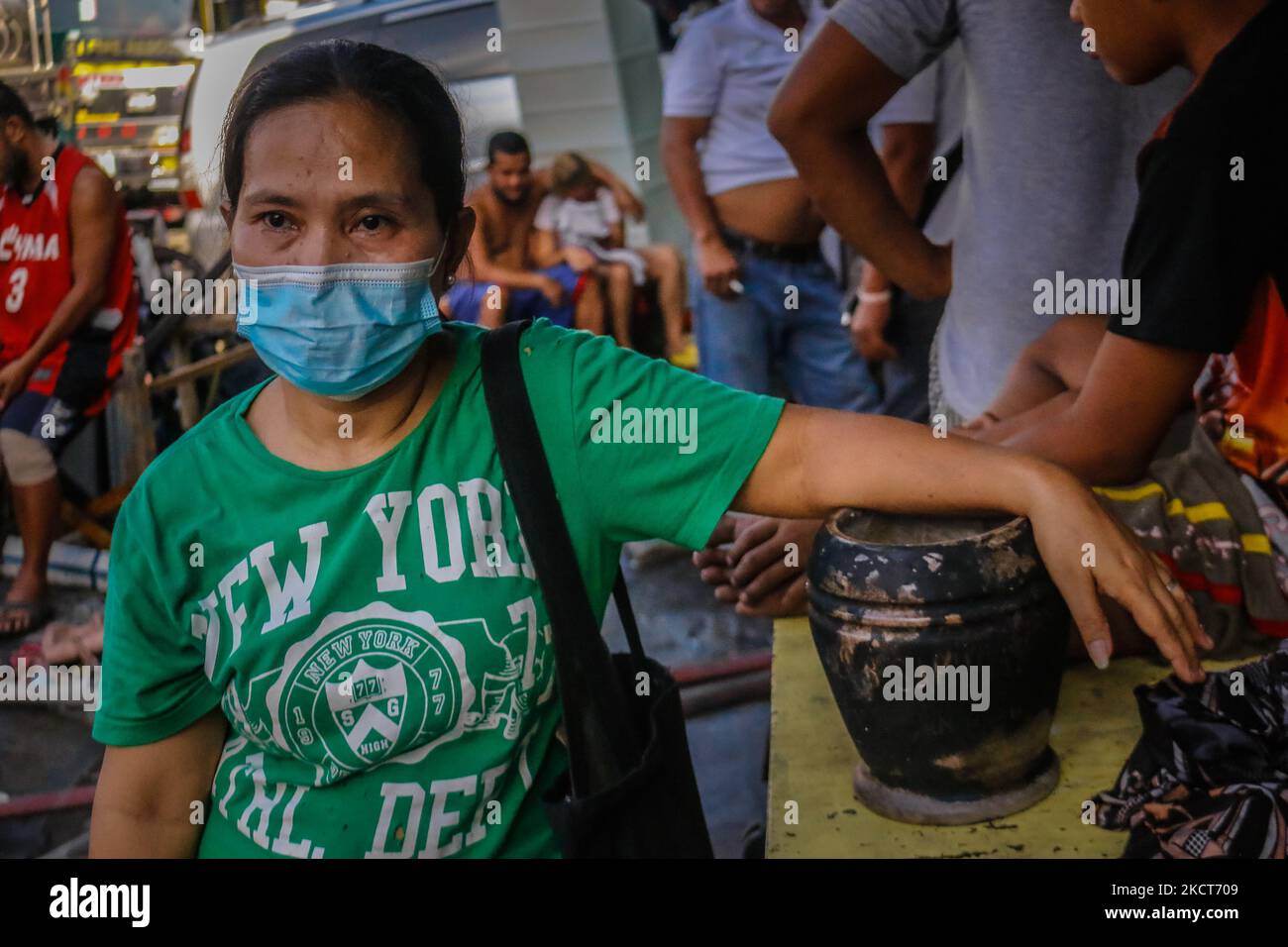 Lanie Diaz-Sabugar, in green, recovers her husband's urn after the 2nd ...