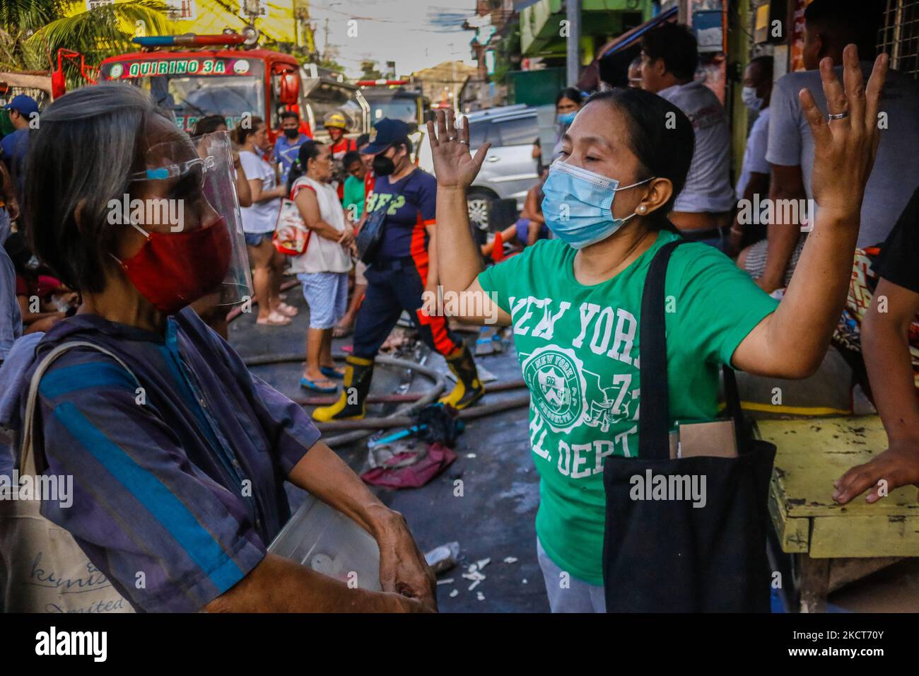 Lanie Diaz-Sabugar, in green, recovers her husband's urn after the 2nd ...