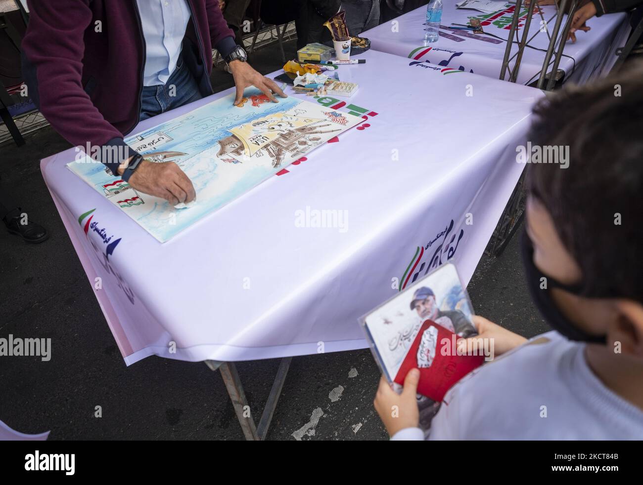 A schoolboy holds a portrait of the Iranian former commander of the ...