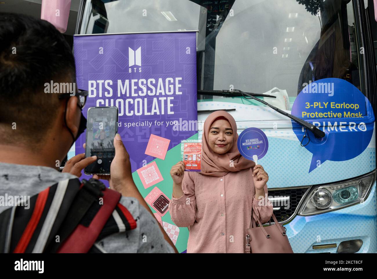 An Indonesian fan of South Korean K-pop boy band BTS take pictures with ...