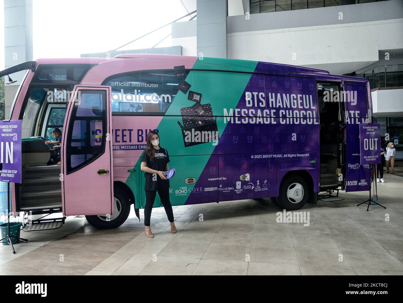 An Indonesian fan of South Korean K-pop boy band BTS poses with a bus ...