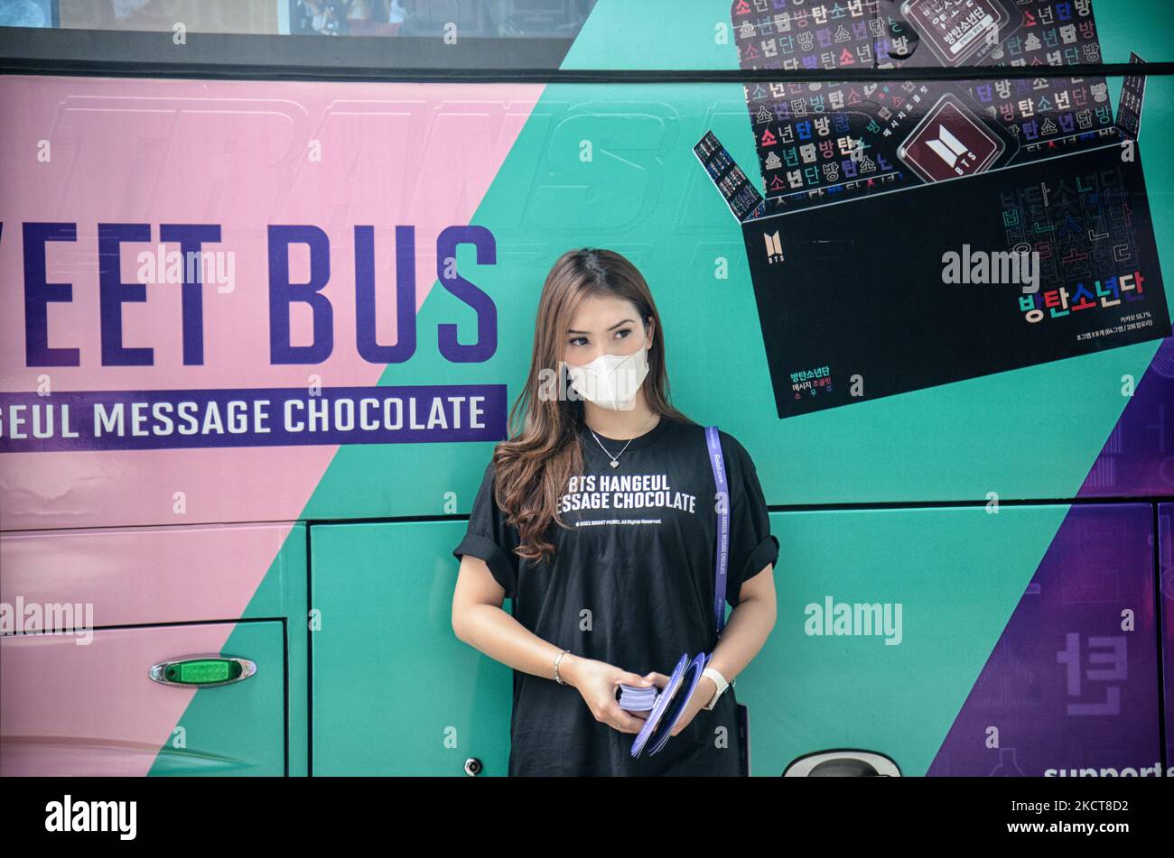 An Indonesian fan of South Korean K-pop boy band BTS poses with a bus ...