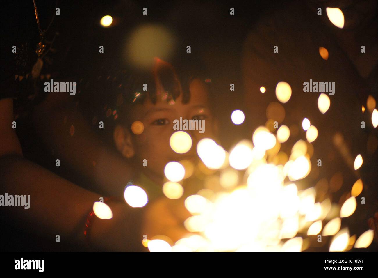 A Little Boyburns sparklers (fire crackers) in during Laxmi Puja of ...