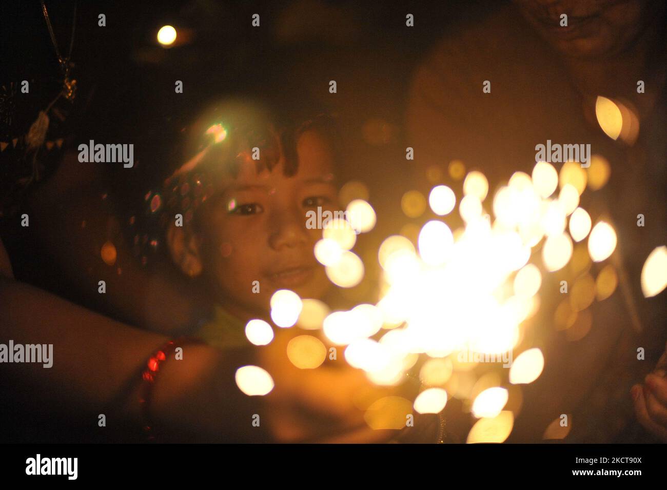 A Little Boyburns sparklers (fire crackers) in during Laxmi Puja of ...