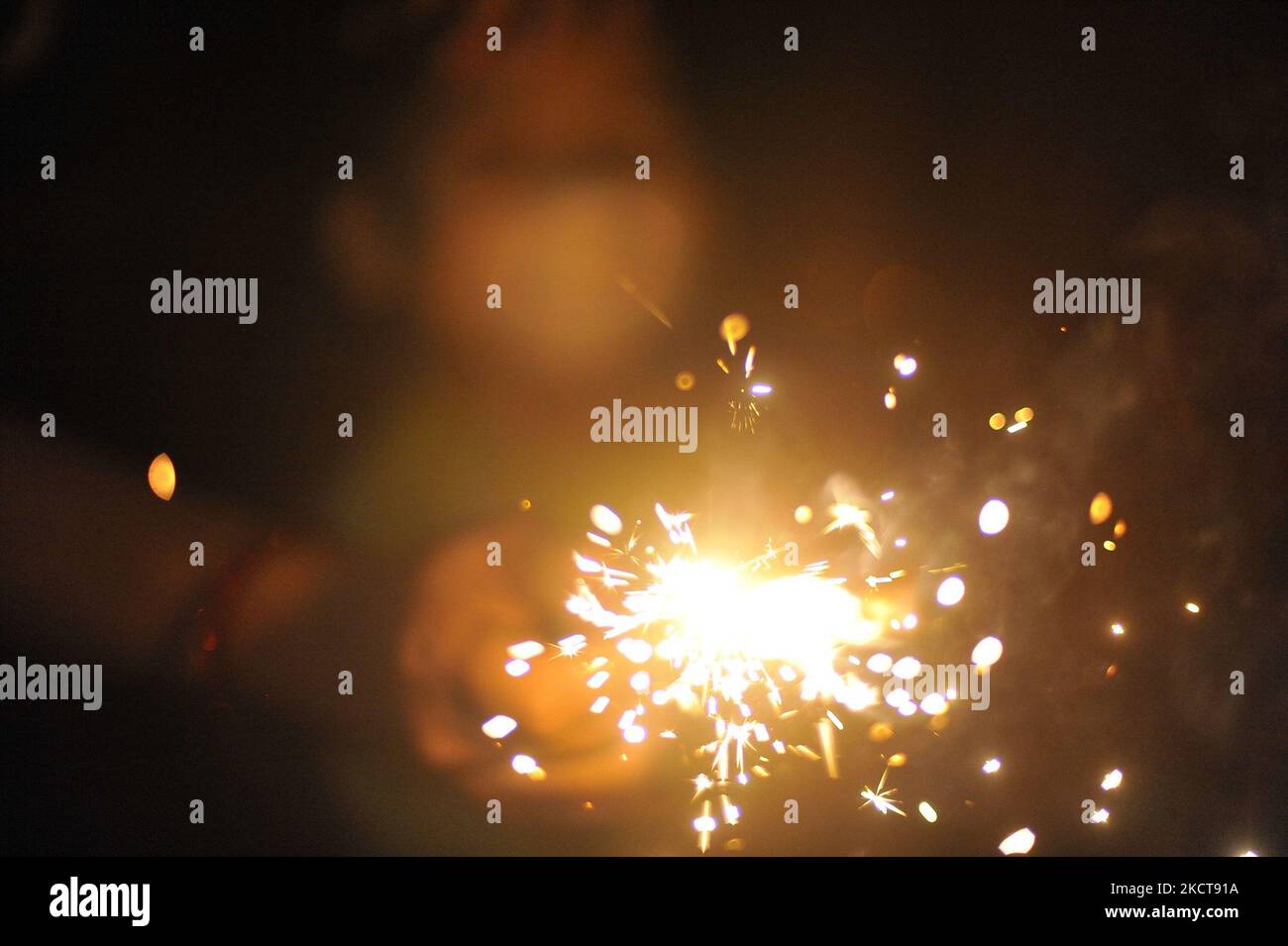 A Little Boyburns sparklers (fire crackers) in during Laxmi Puja of ...