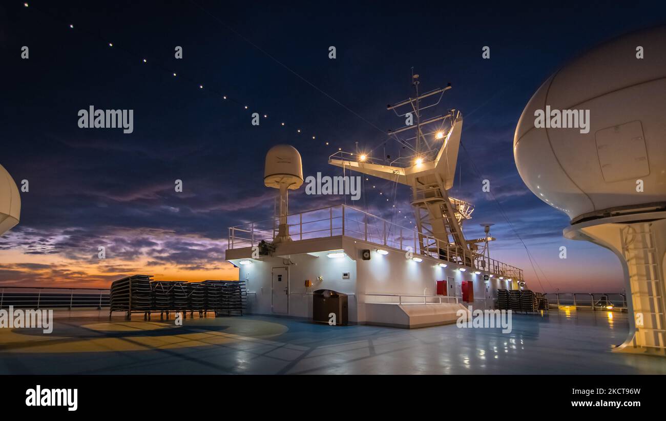Promenade deck of a cruise ship in navigation with sunset Stock Photo ...
