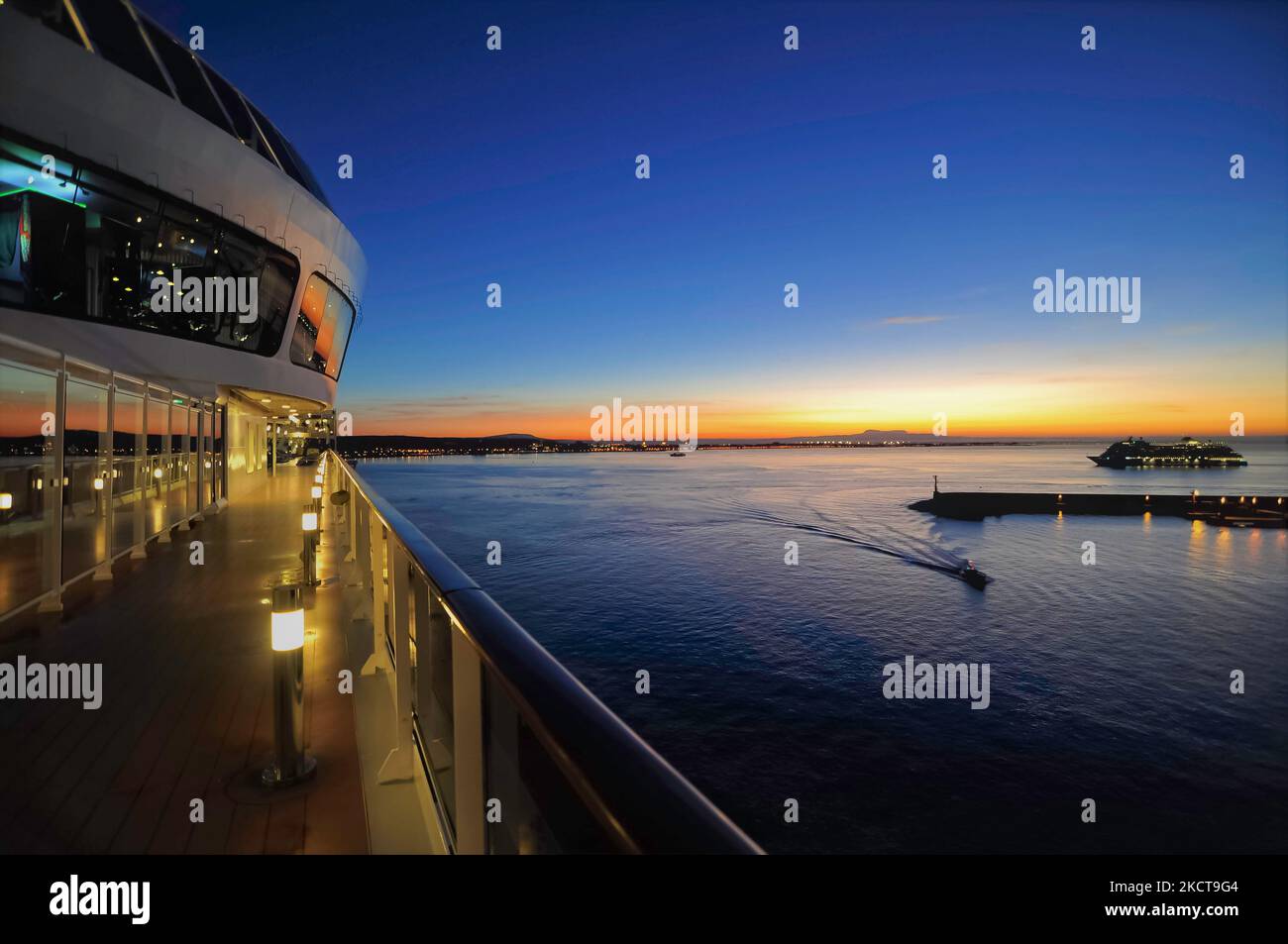 Promenade deck of a cruise ship in navigation with sunset Stock Photo ...