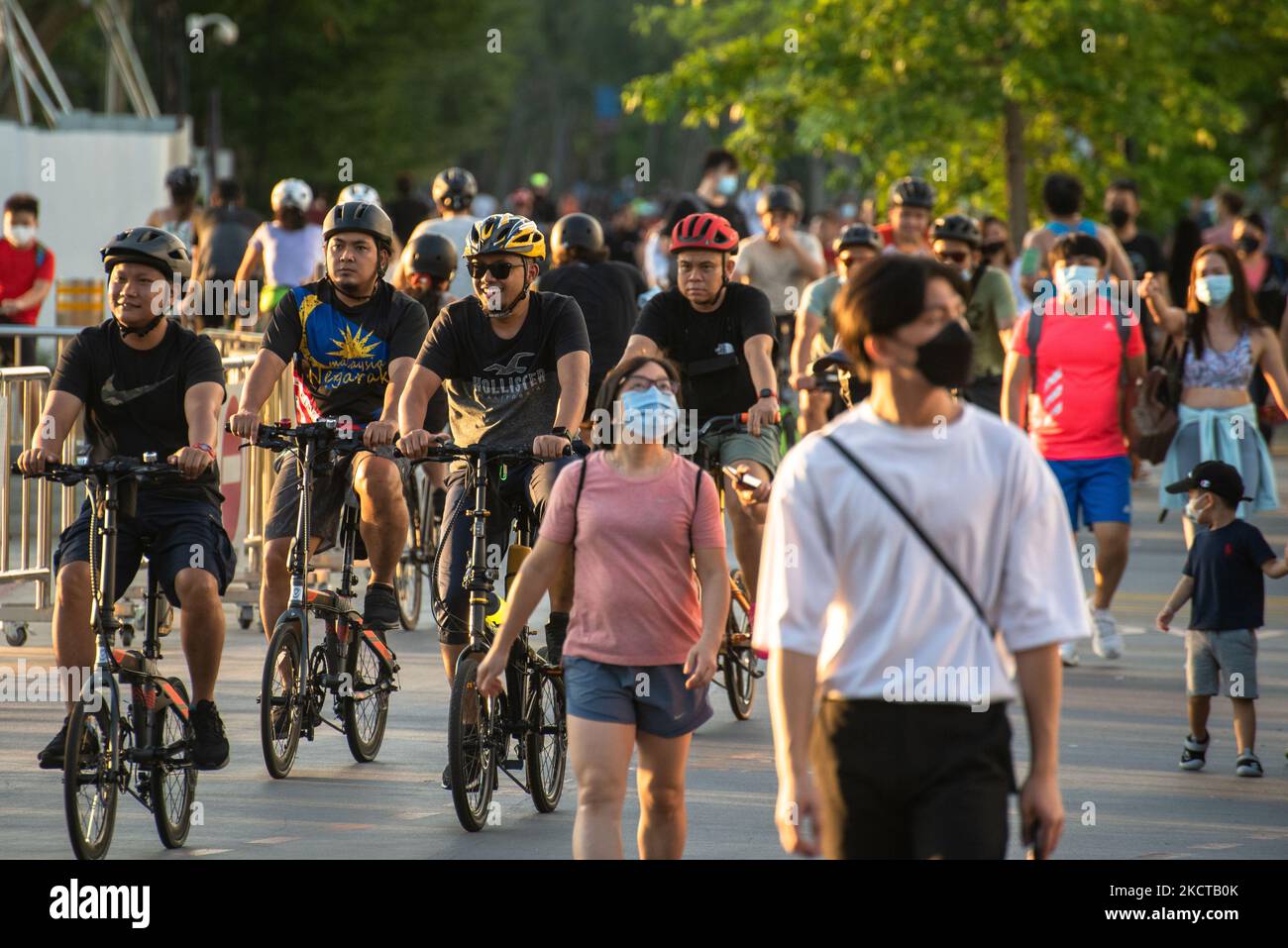 People cycle and walk on a crowded walkway at the Gardens by the Bay ...