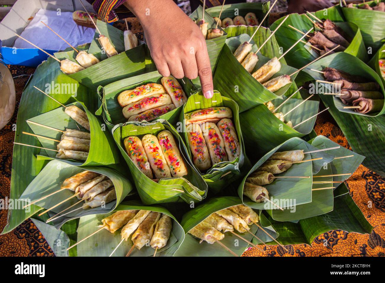 Tourists visit the Sawahan Market, a traditional snack market in ...