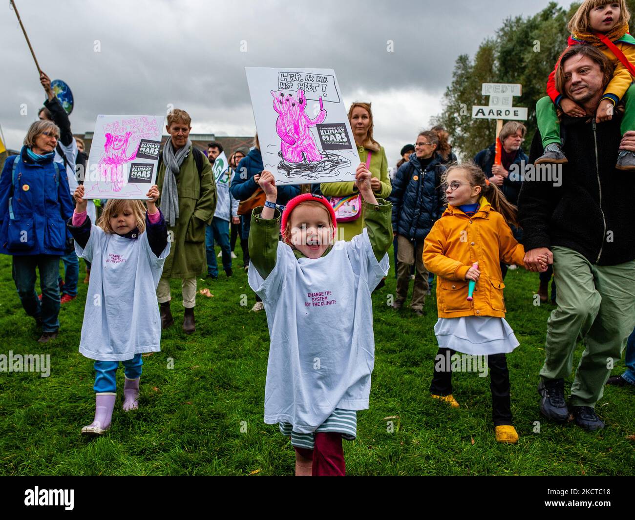A group of very young children is holding placards against climate ...