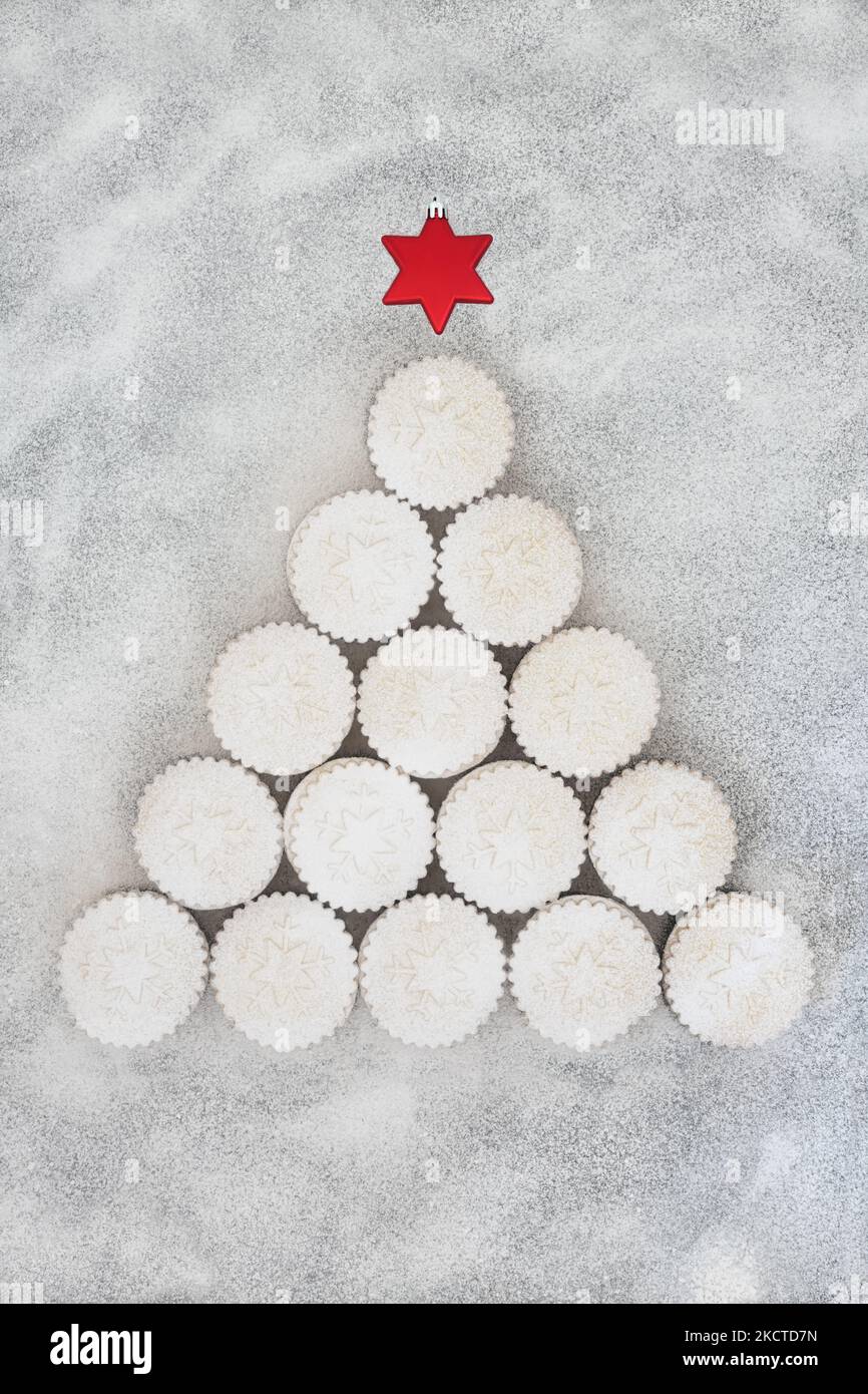 Christmas snow mince pie food and red star decoration on snow ...