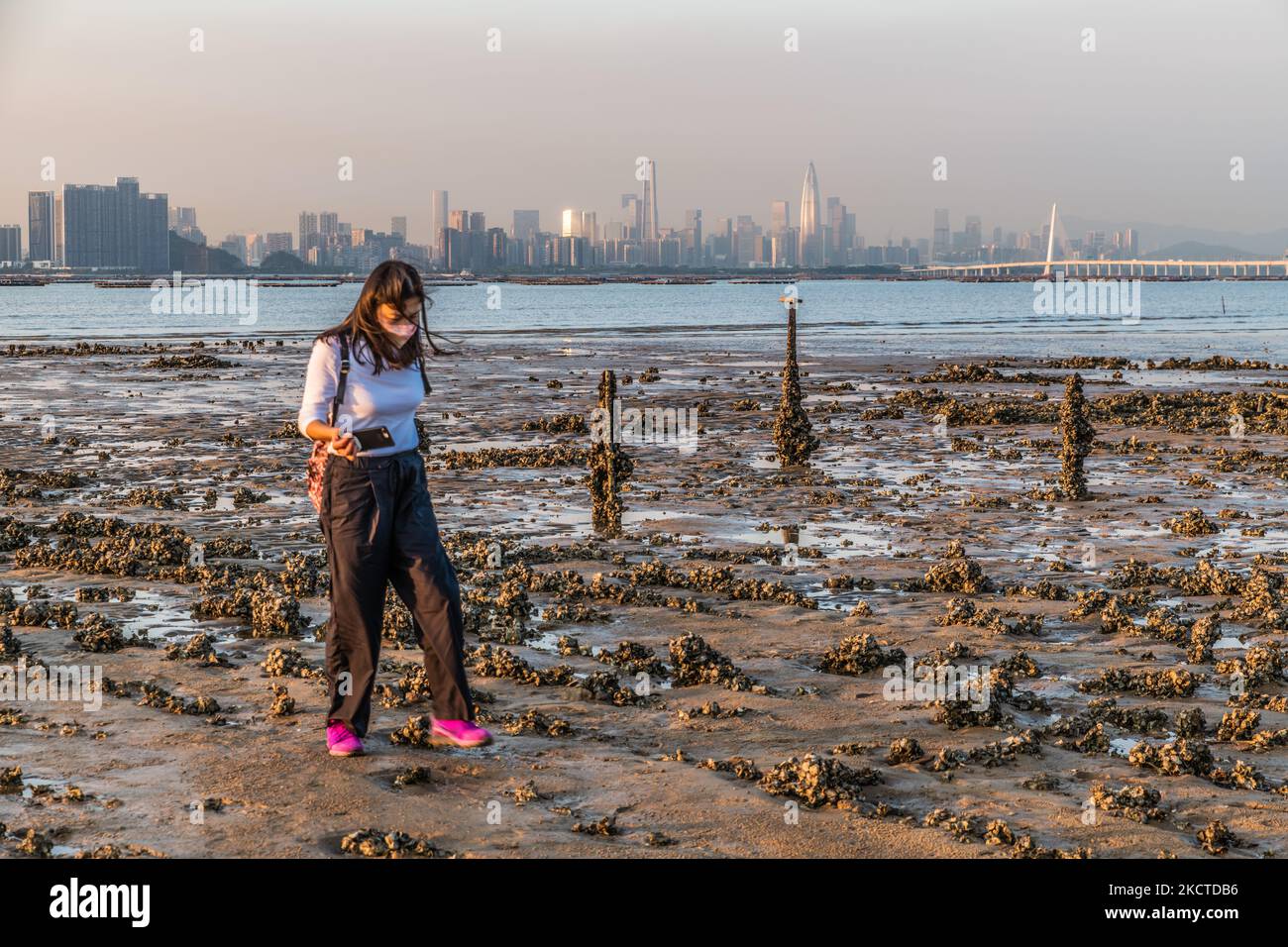 Hong Kong, China, 6 Nov 2021, A Hong Kong resident walks at low tide on ...
