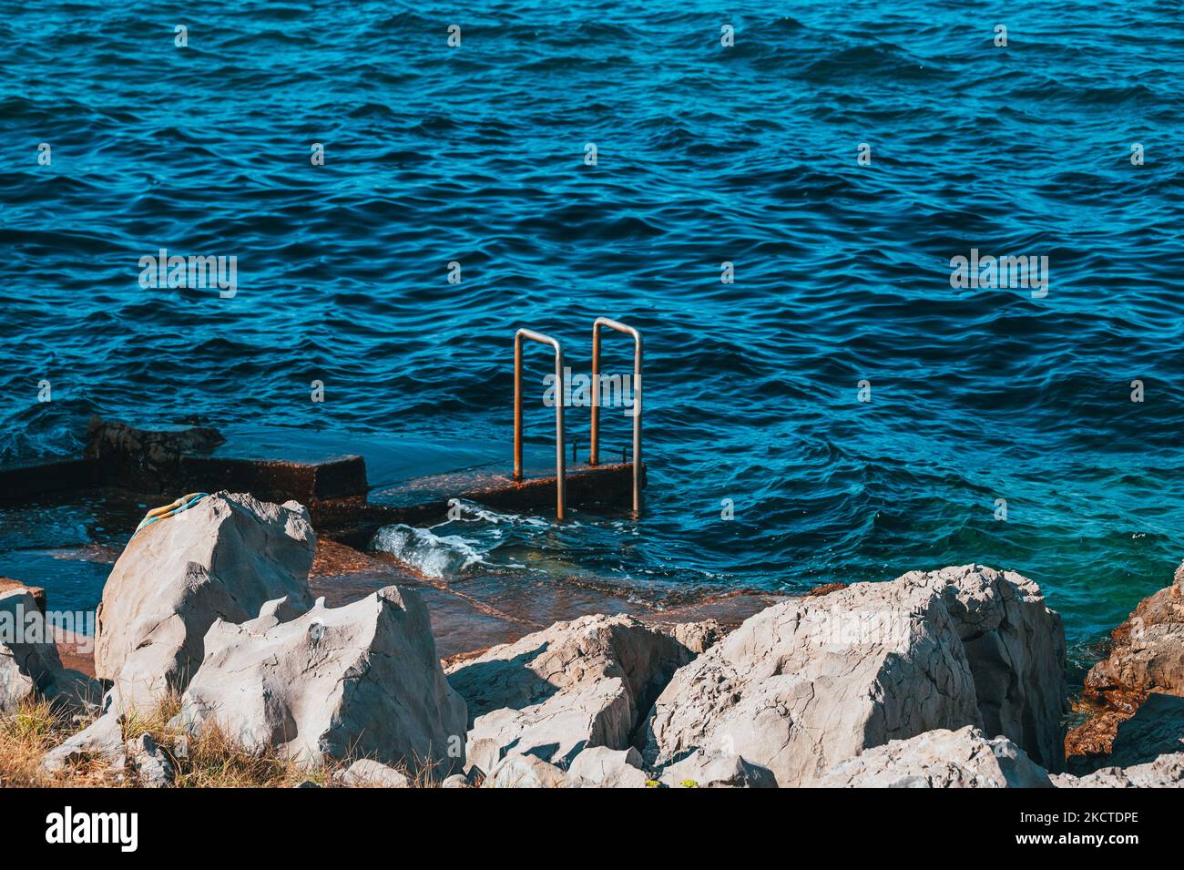 Pier and ladder. Entrance to the beach in the Mediterranean Sea. Photo ...