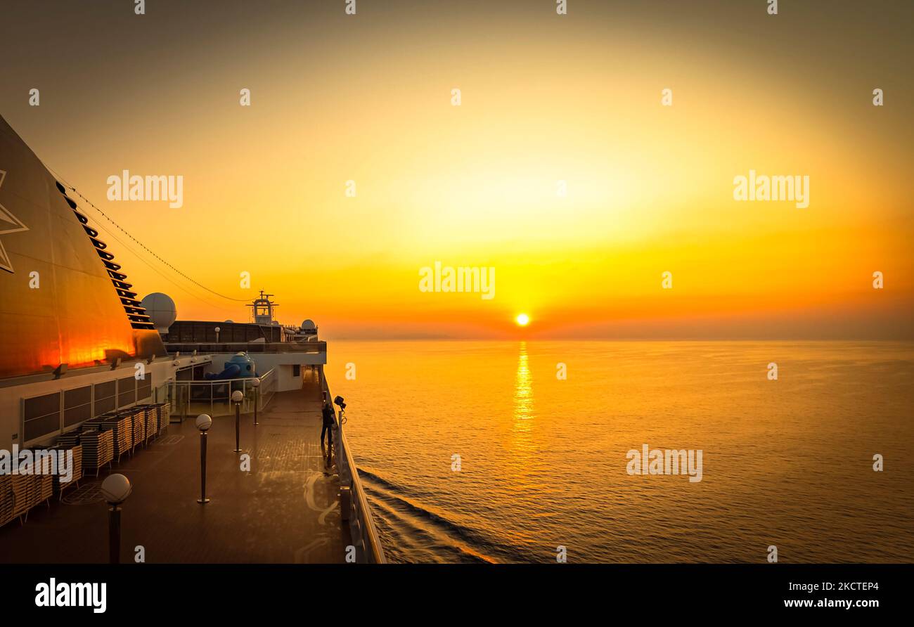 Promenade deck of a cruise ship in navigation with sunset Stock Photo ...