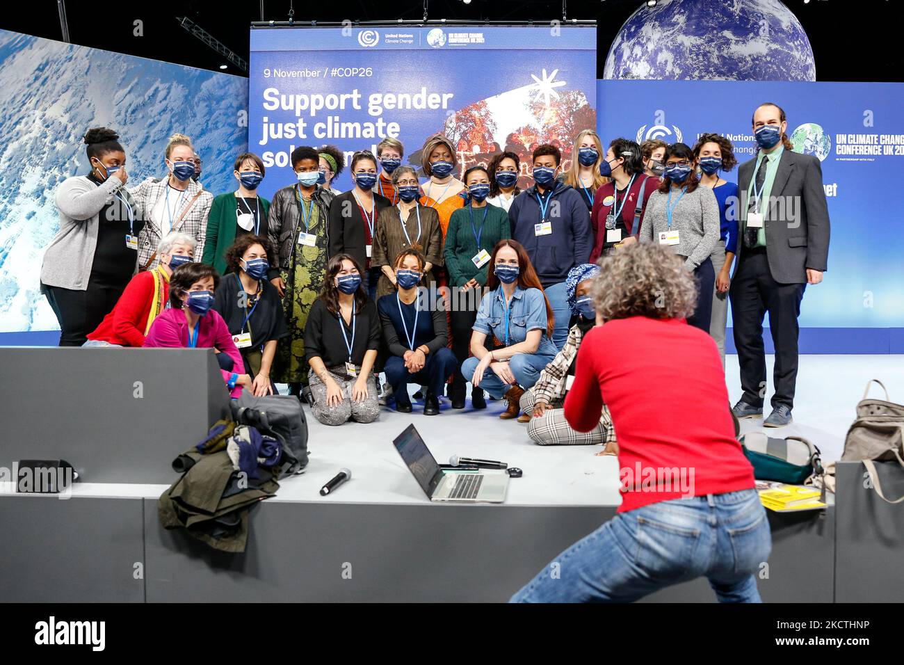 Participants take a group photo in Action Hub during the tenth day of ...