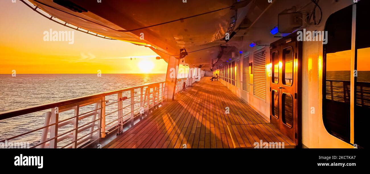 Promenade deck of a cruise ship in navigation with sunset Stock Photo ...