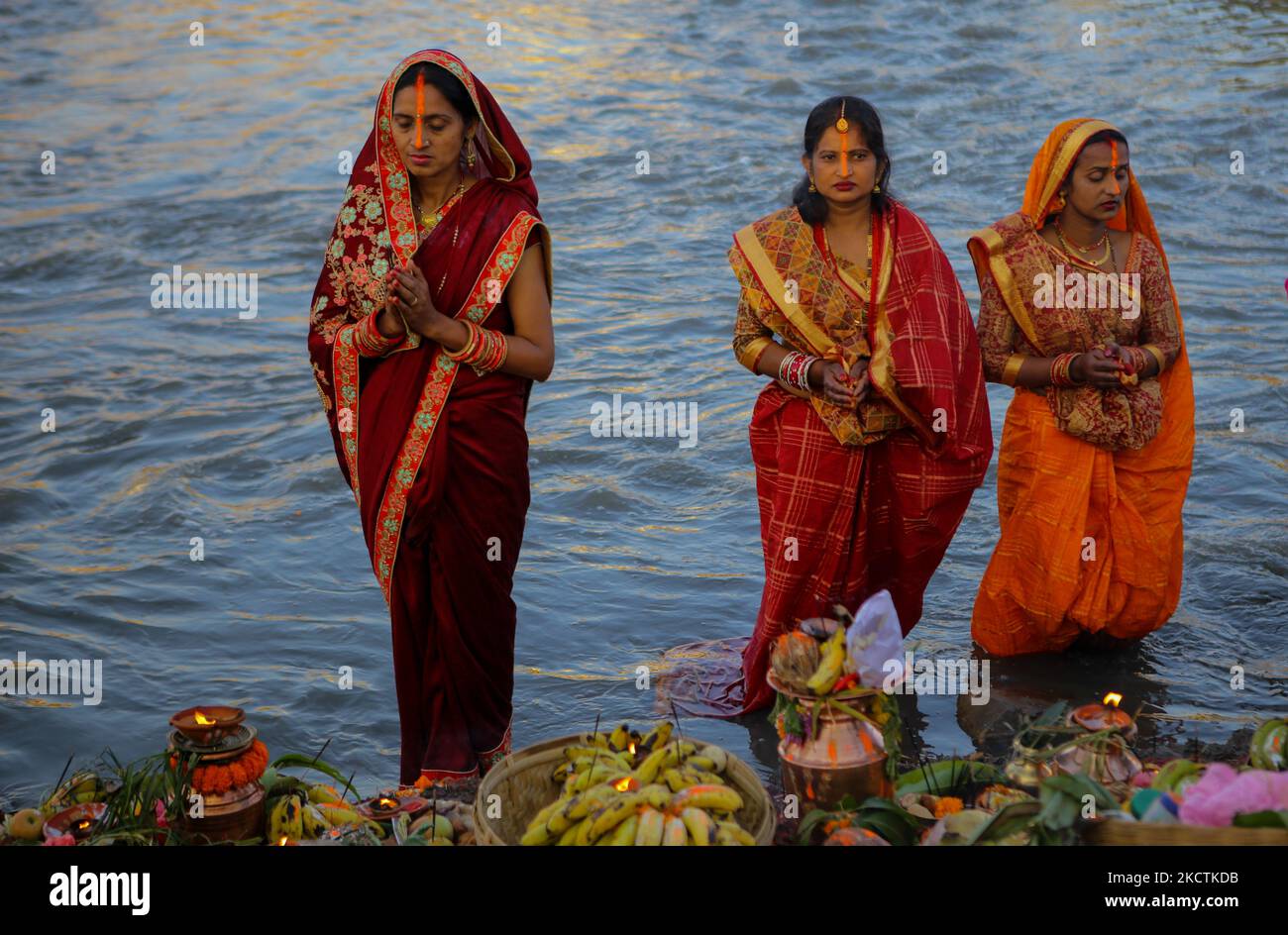 Hindu Devotees pray to the setting Sun on the occasion of Chhath Puja ...