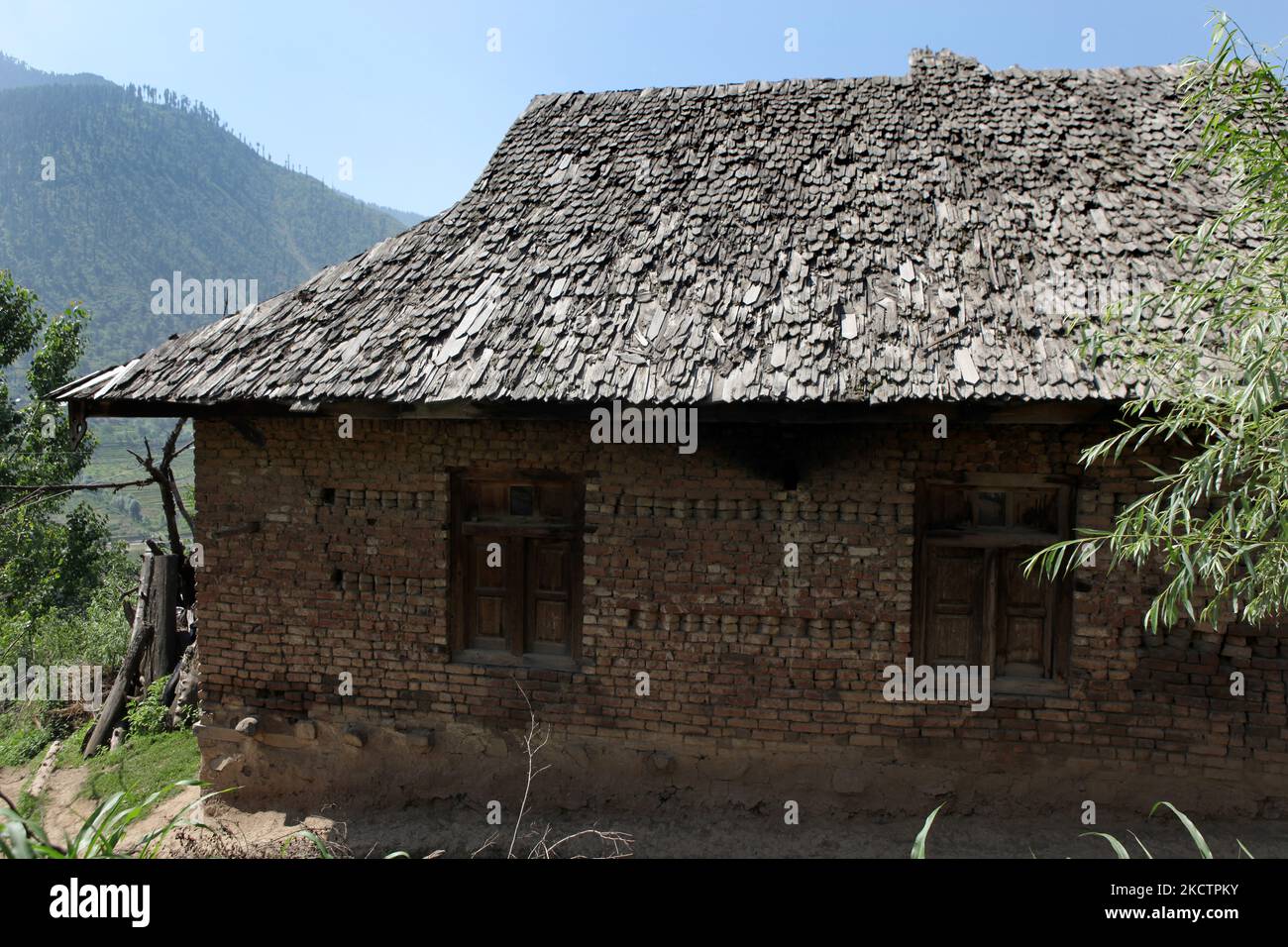 An old traditional Kashmiri Gujjar house with wooden shingles in ...