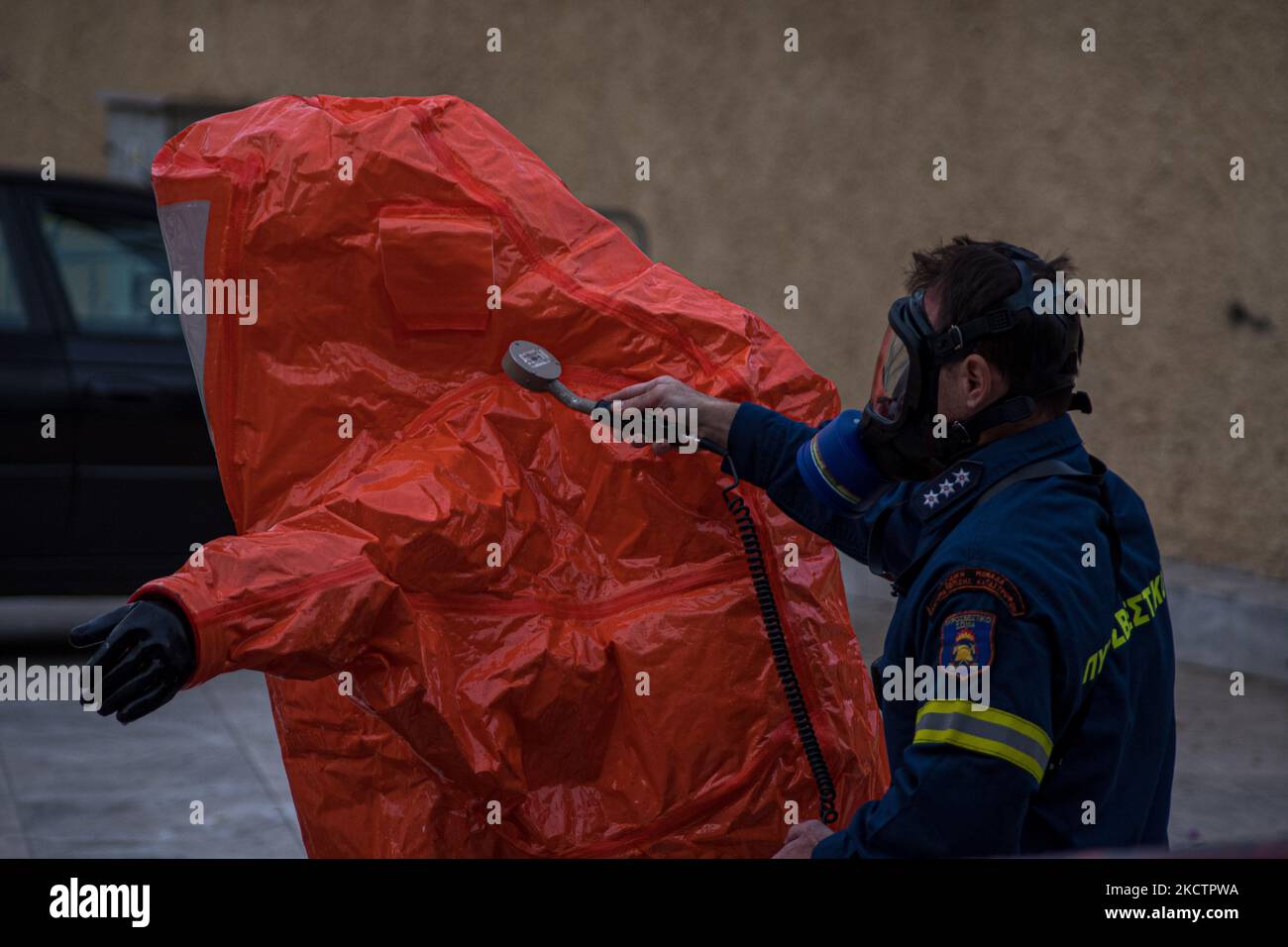 Pyrotechnicians of the Hellenic Fire Service getting checked for ...