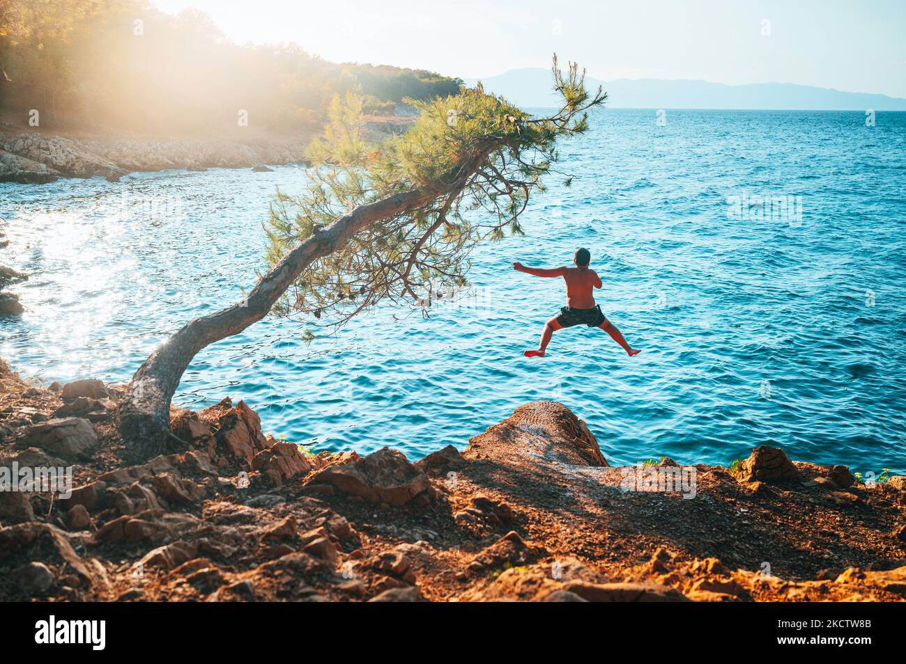 Man Jumping to the water of blue Mediterranean Sea. Active Summer ...