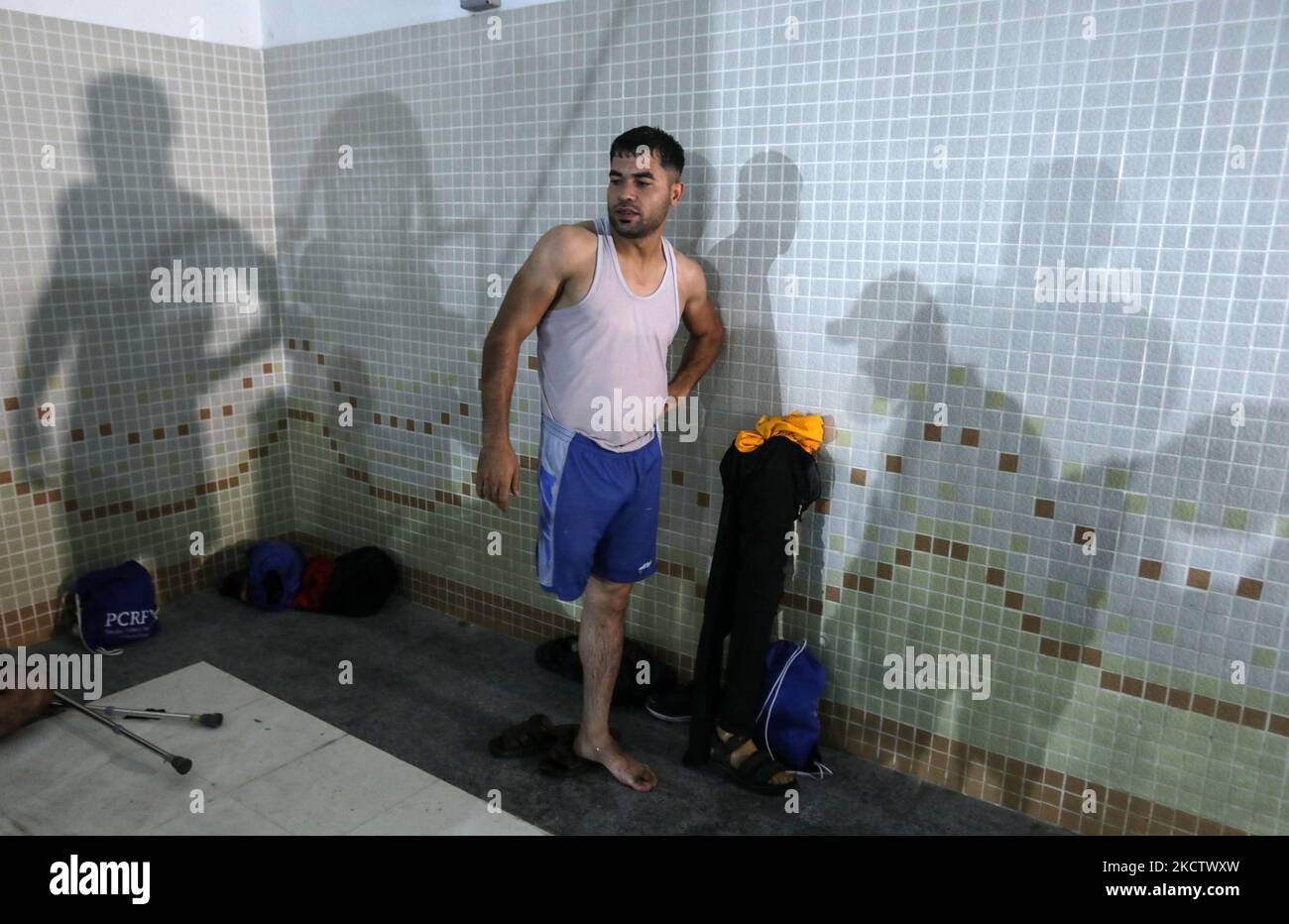 A Palestinian amputee rests after taking part in a swimming training ...