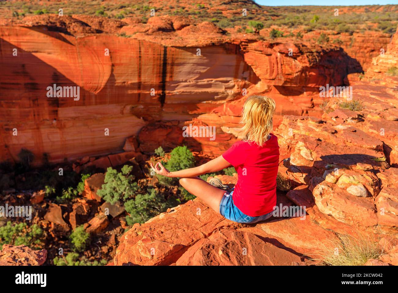 Peaceful woman doing yoga meditation in lotus pose at edge of Kings ...