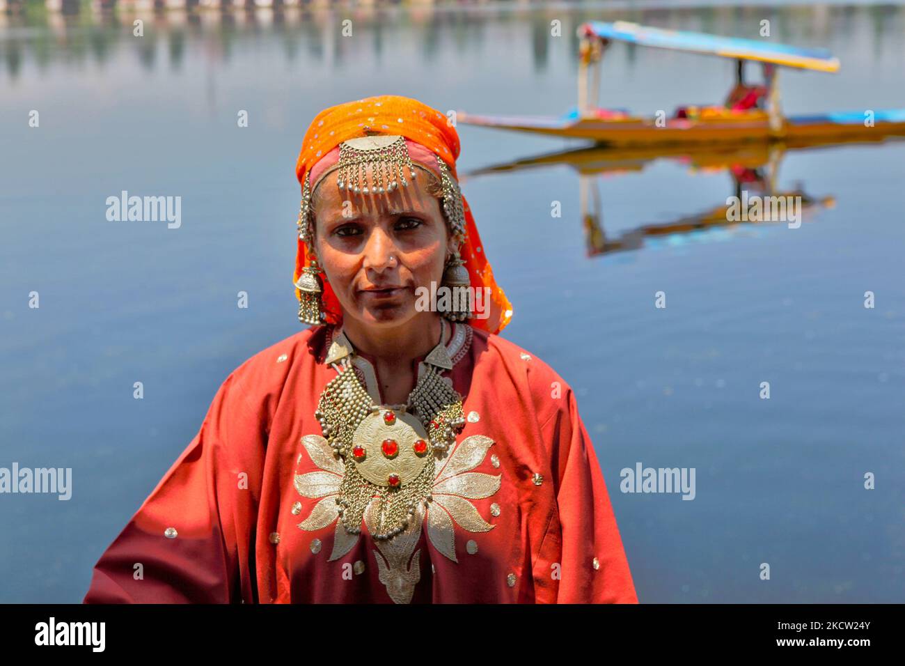 Kashmiri Muslim woman dressed in traditional finery with Dal Lake seen ...