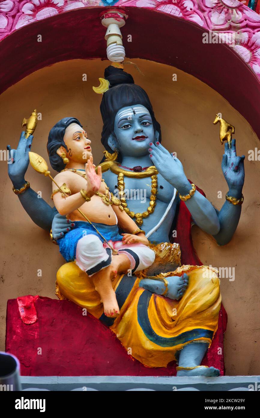 Figures of Lord Shiva with Lord Murugan on his lap adorn a Hindu temple ...